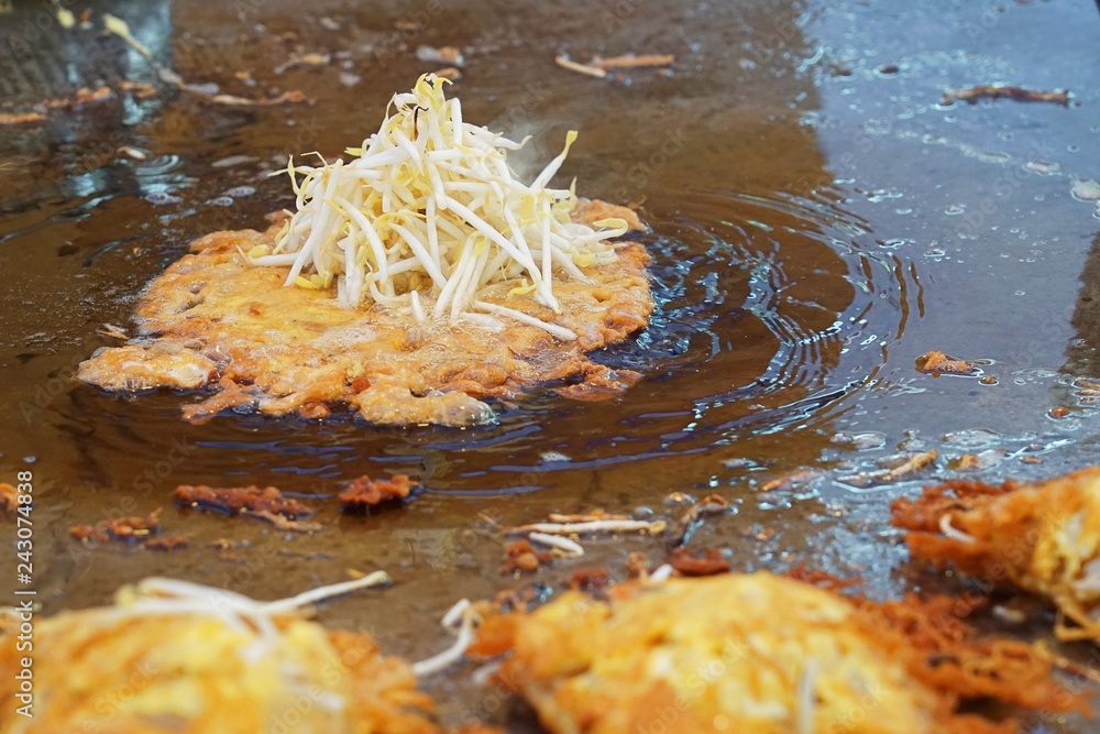 Crispy Fried Mussels and oyster omelette with sprouts cooking in large ...