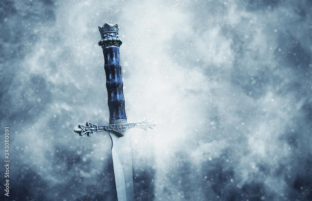 mysterious and magical photo of silver sword over gothic snowy black ...