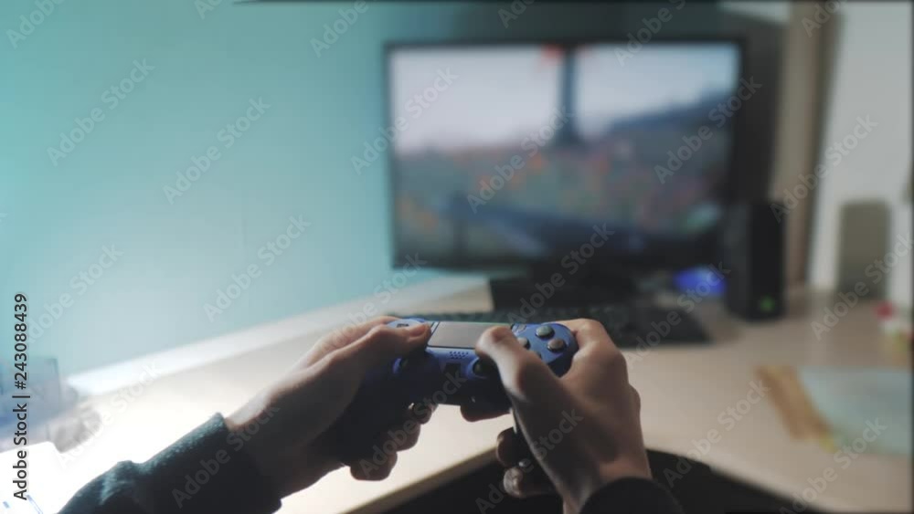 Vidéo Stock boy is playing on controller joystick gamepad the console ...