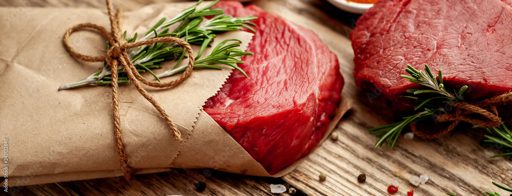 two pieces of meat from the butcher shop, one piece of meat wrapped in ...