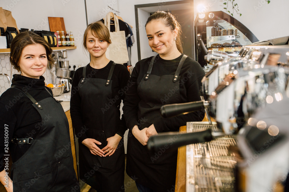 Foto de Team female baristas coworkers standing in workplace at coffee ...