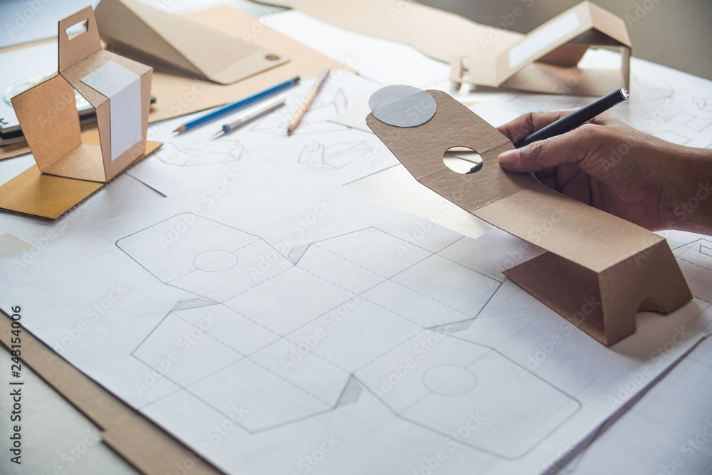 Designer sketching drawing design Brown craft cardboard paper product ...