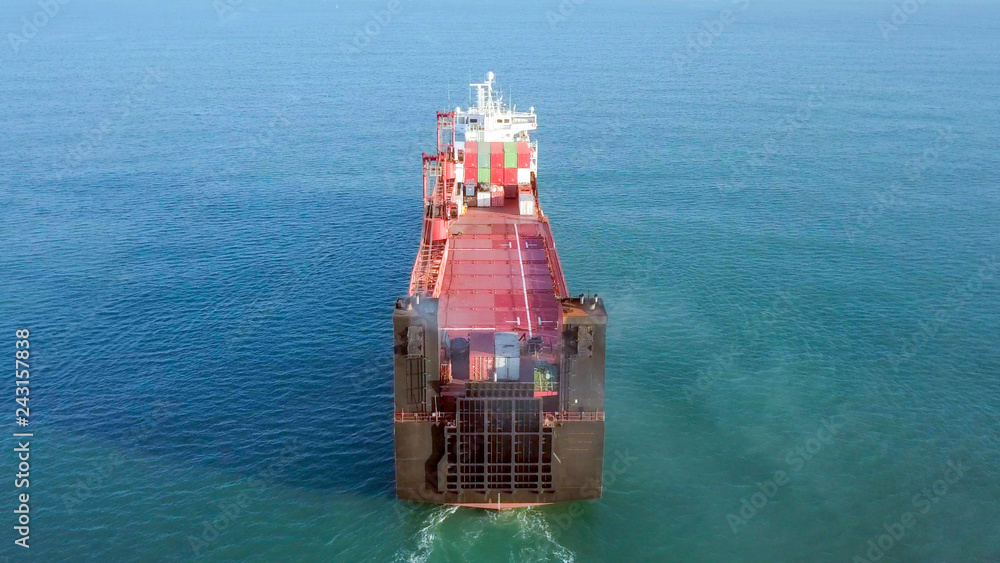 Large Cargo and RoRo (Roll On-Off) ship at sea, loaded with a small ...