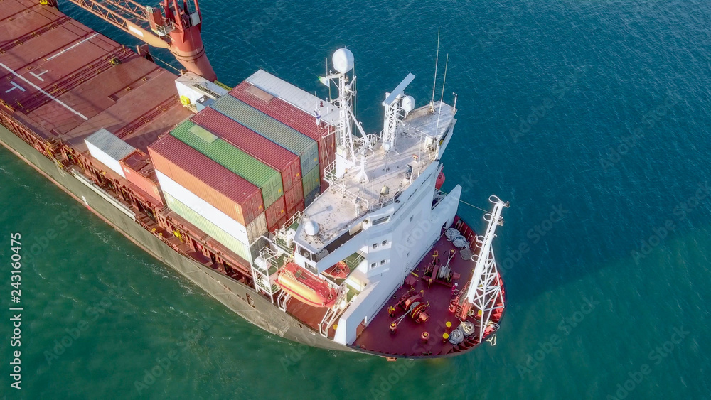 Large Cargo and RoRo (Roll On-Off) ship at sea, loaded with a small ...