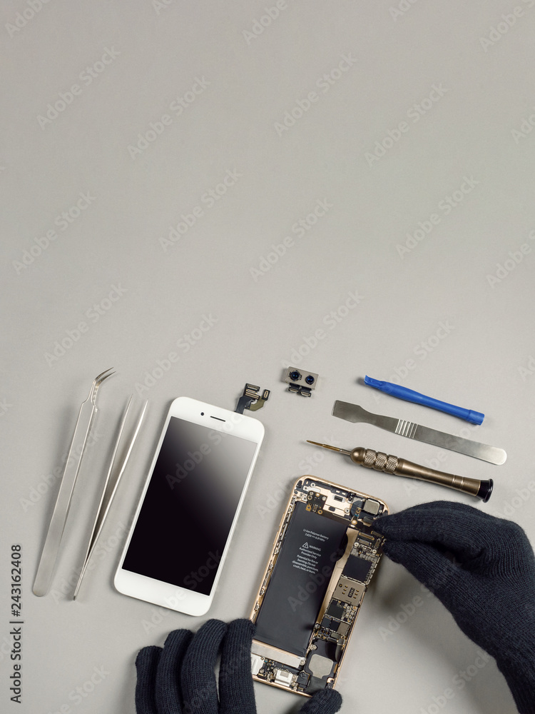 Technician or engineer disassembling components broken smartphone and ...