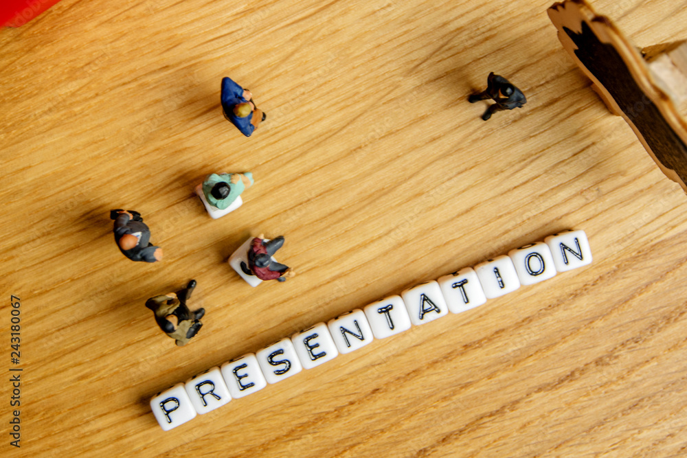 little miniature figurines with little dices forming word presentation ...