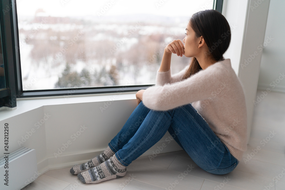 Depressed young girl feeling sad an lonely, anxious looking out the ... Depressed young girl feeling sad an lonely, anxious looking out the ...