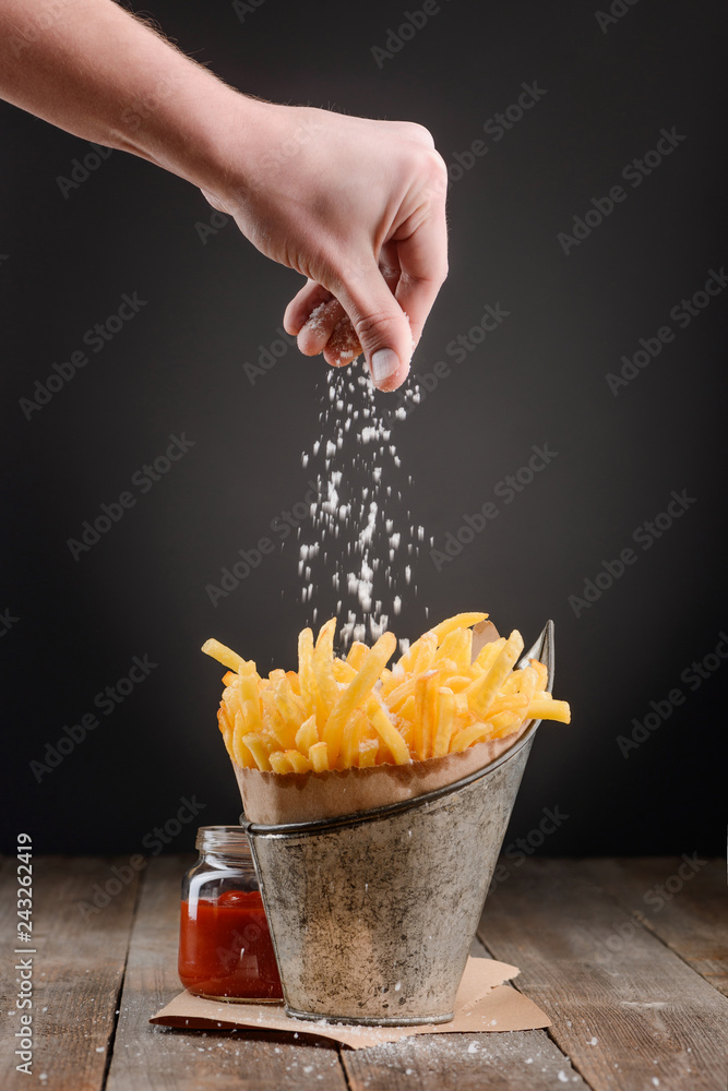 Hand adding a pinch of salt Stock Photo | Adobe Stock