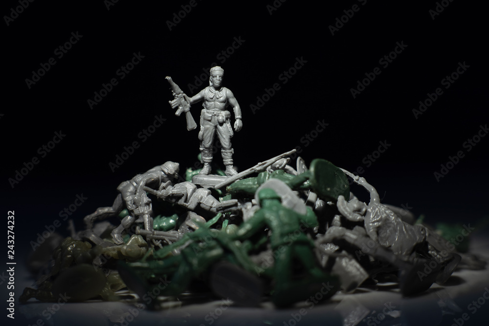 Image one soldier standing over the dead plastic toy soldier against ...