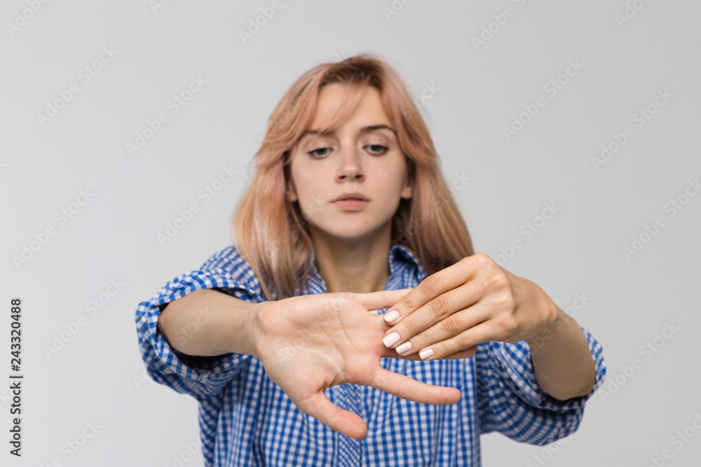 Studio portrait of young woman suffering from pain if arms, weakness ...