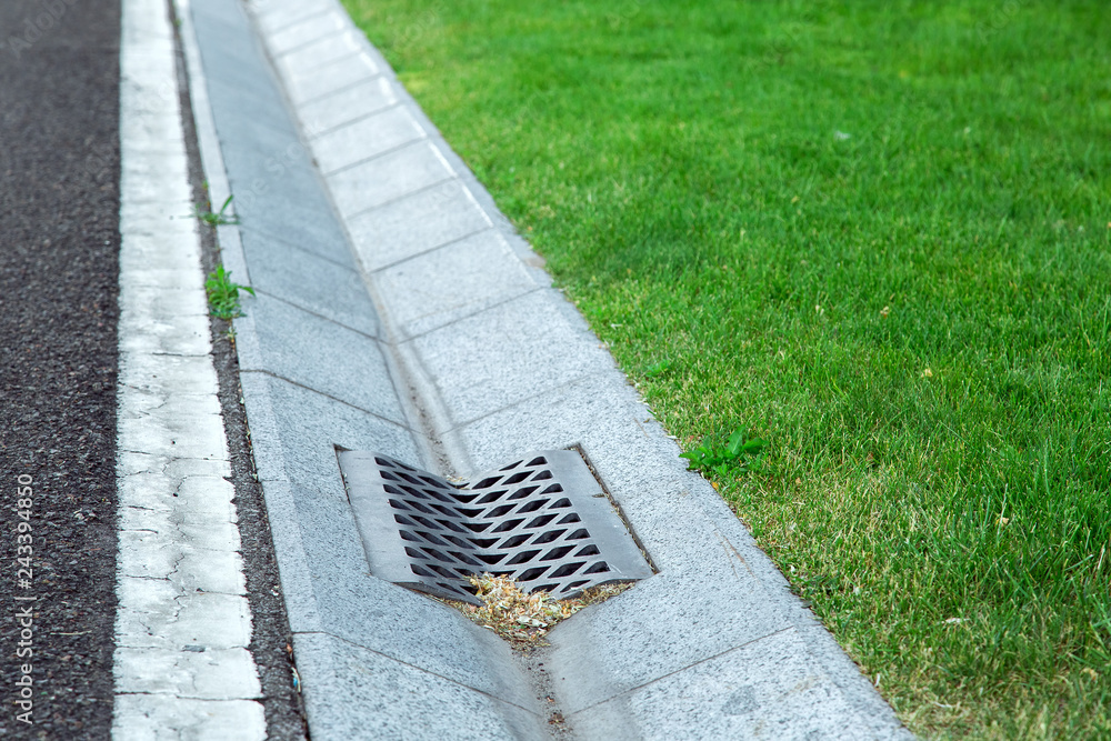 gutter of a stormwater drainage system in perspective on the side of an ...