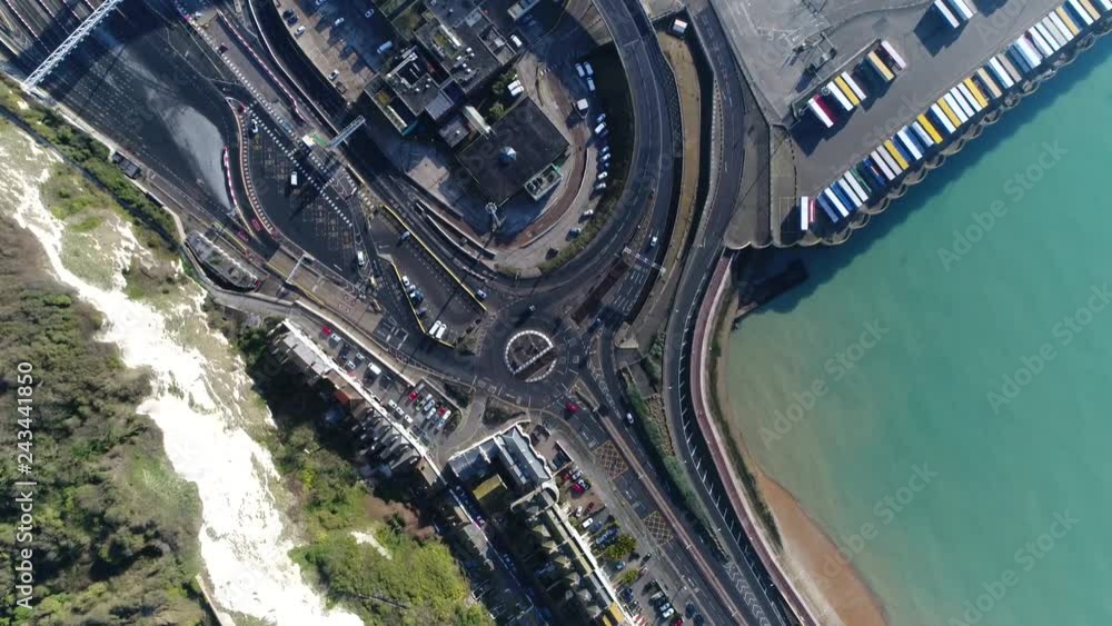 Aerial top down view arriving at harbor area showing road leading to ...