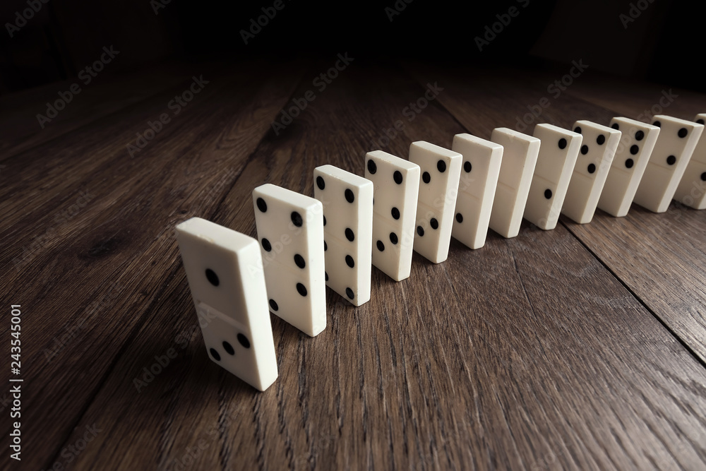 Creative background, white domino, on brown wooden background. Concept ...