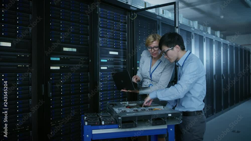 In the Modern Data Center: Engineer and IT Specialist Work with Server ...