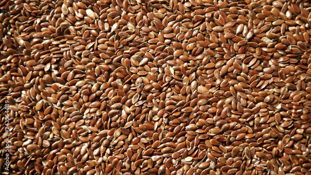 Brown raw flax seeds linseed as natural food background or grain texture. Flaxseeds full of ...