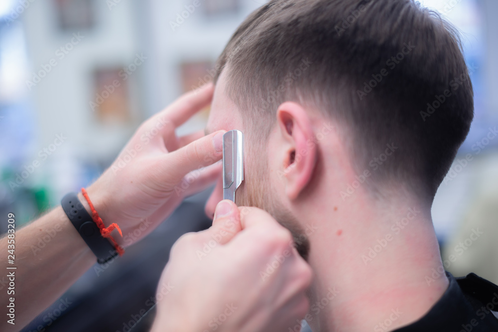 The process of cutting a beard. Shaving a dangerous razor in a ...