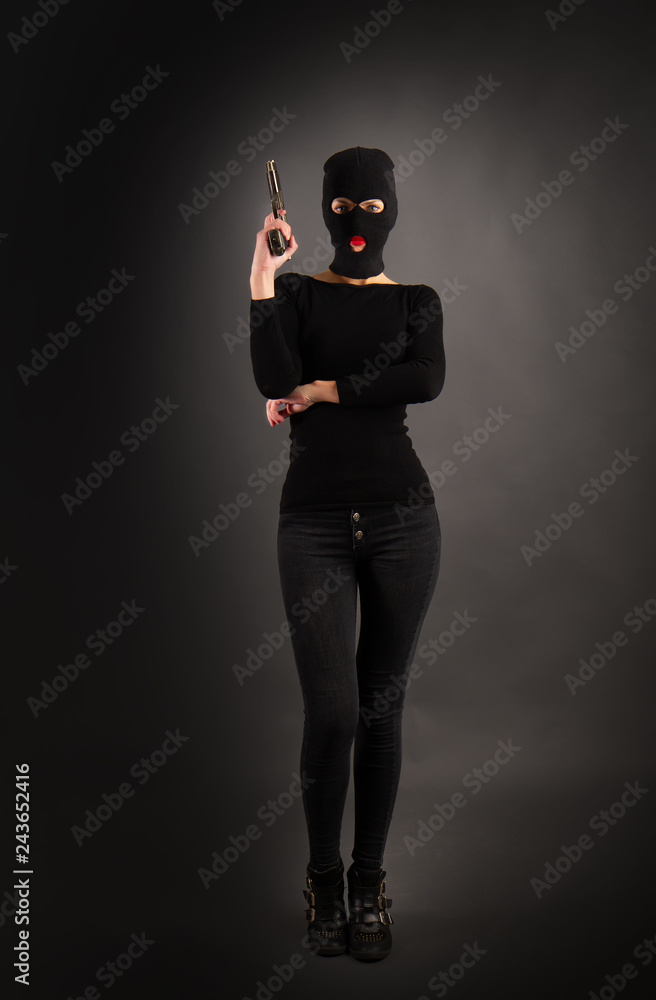 Girl in Black with Gun Stock Photo | Adobe Stock