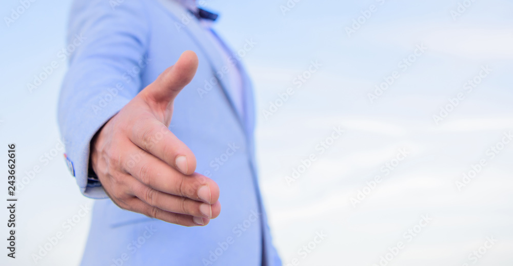 Hand of businessman offer hand for handshake blue sky background ...