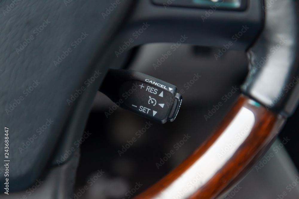 The shift lever to set the automatic cruise control speed inside the ...