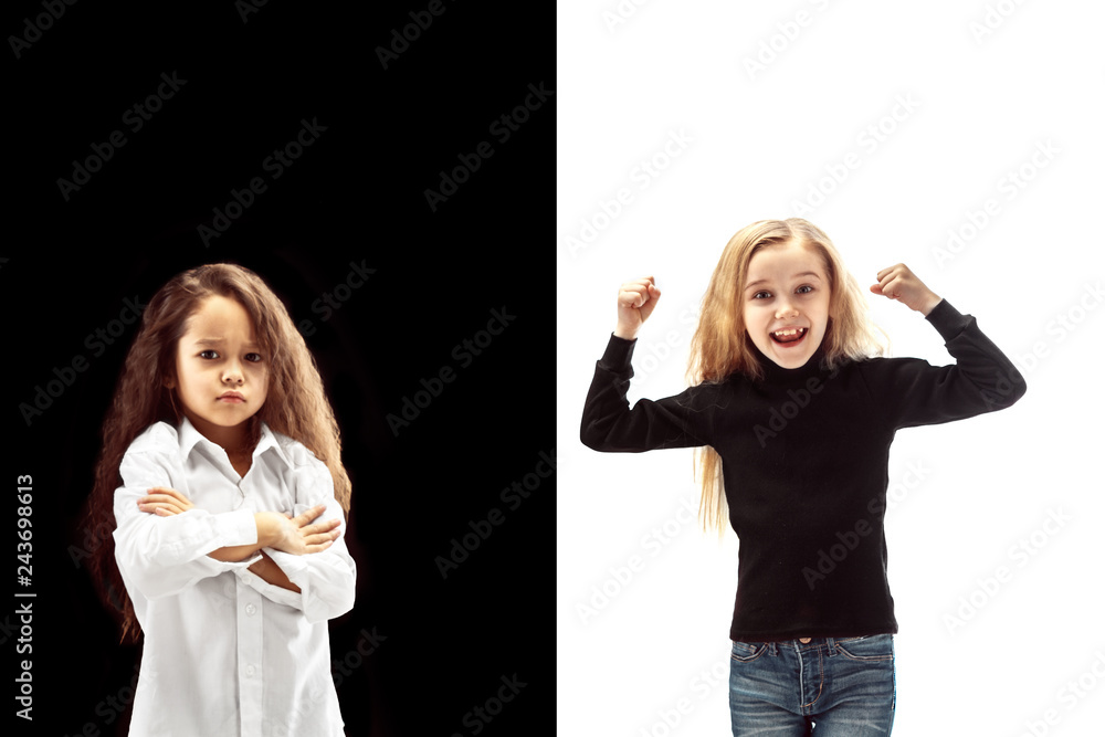 The portrait of emotional happy winner girl and serious girl on a white ...