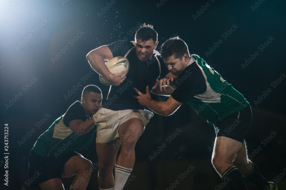 Rugby ball carrier in action Stock Photo | Adobe Stock