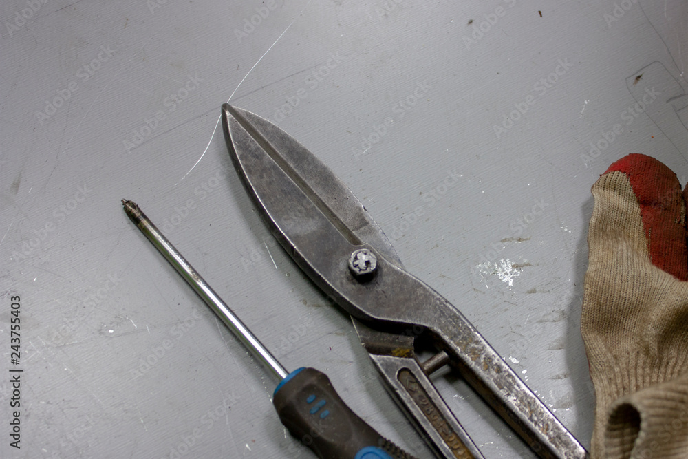 Hand tools, parts of products and blanks on the desktop of the workshop ...
