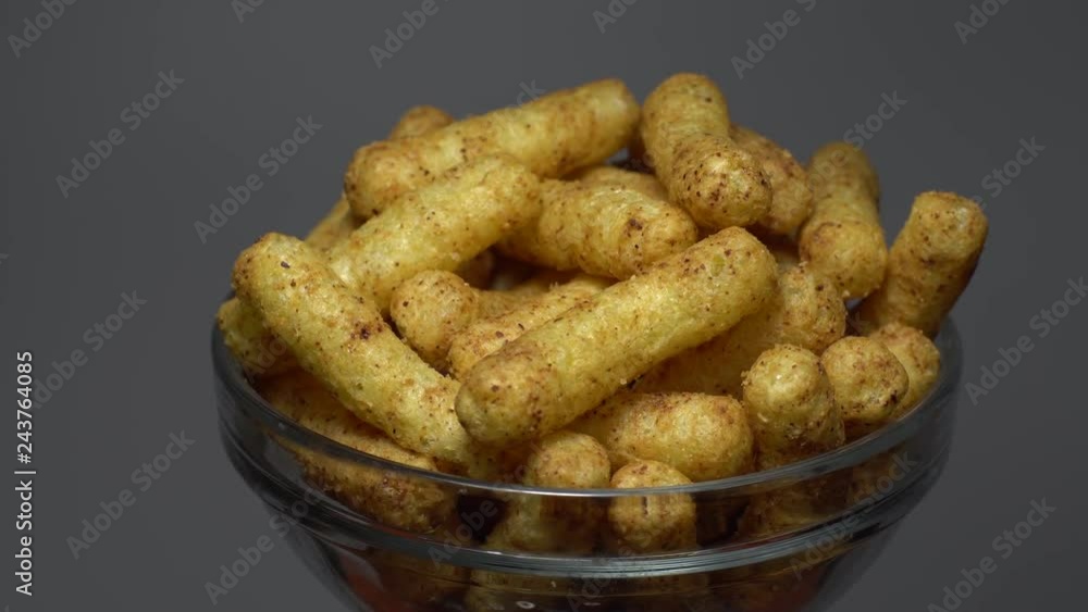 Corn puffs. Rotation. Close up. Puffcorn with peanut flavor. Corn ...