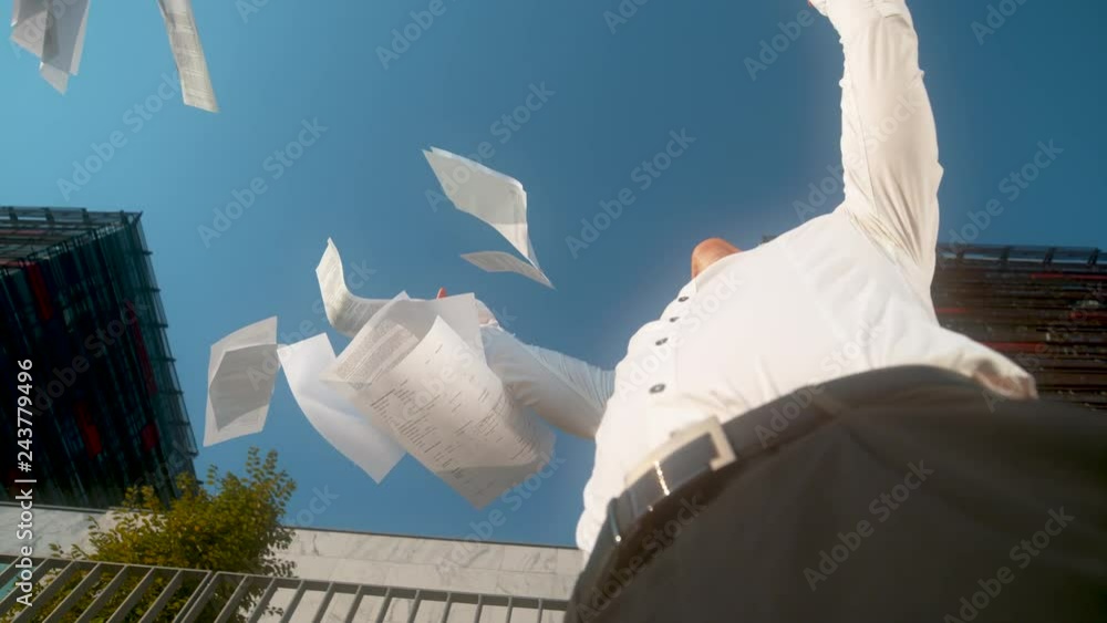 SLOW MOTION, BOTTOM UP, CLOSE UP: Excited young businessman celebrates ...