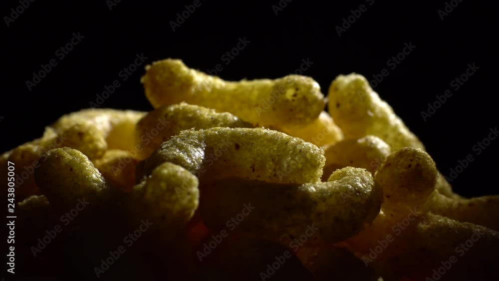 Corn puffs. Rotation. Close up. Puffcorn with peanut flavor. Corn ...