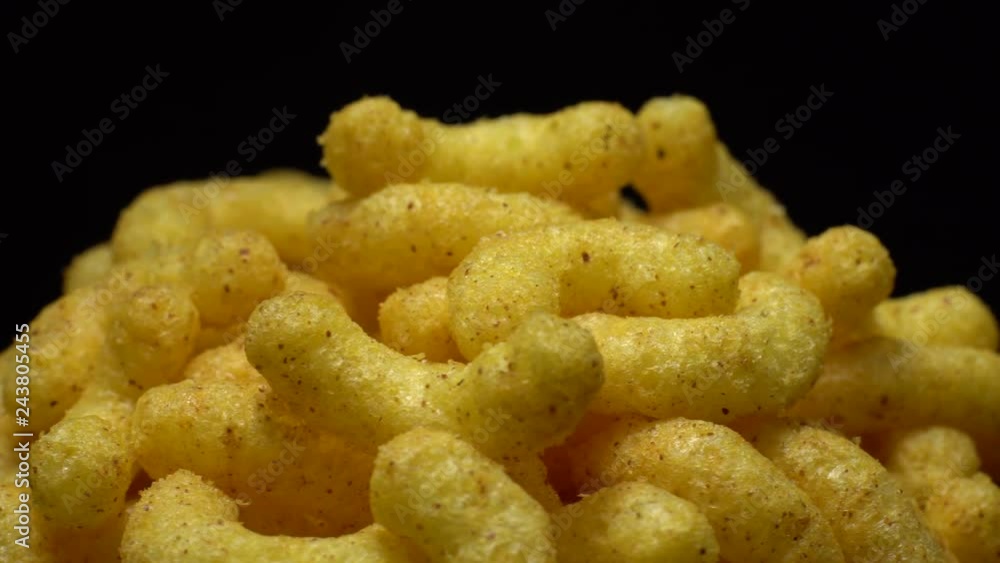 Corn puffs. Rotation. Close up. Puffcorn with peanut flavor. Corn ...