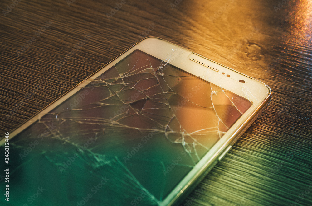 Broken cell phone with display damage and splintered display to ...