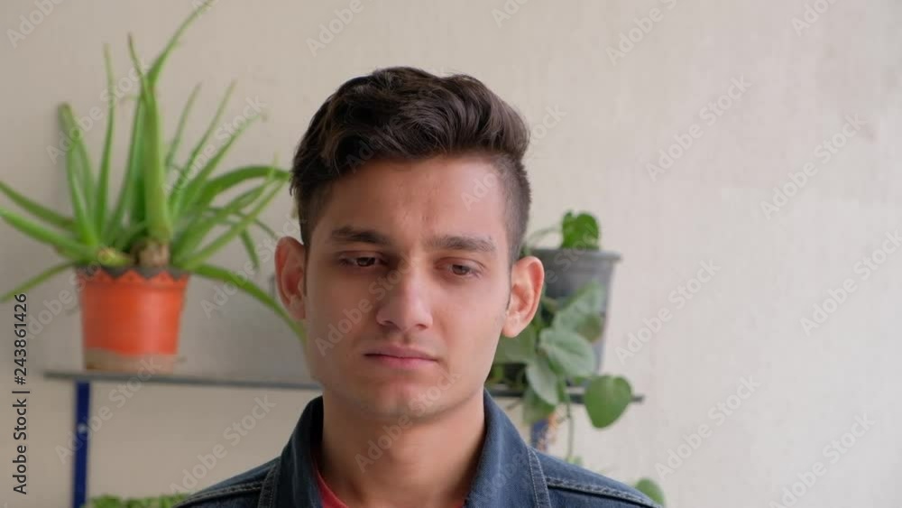 Boy makes faces of trouble and stress as he tries to find a solution to ...