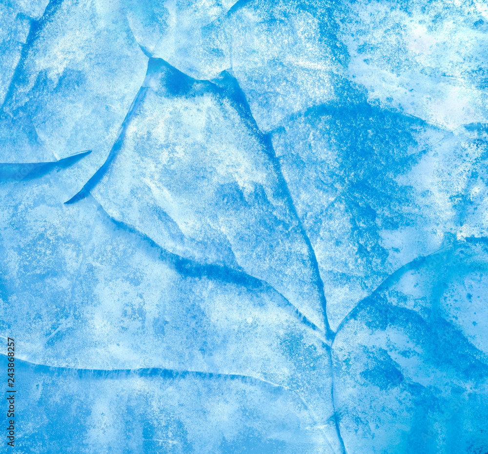 Abstract ice background. Blue background with cracks on the ice surface ...