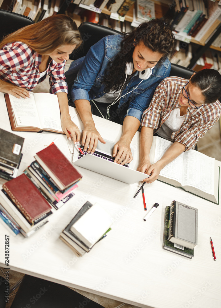 Cute female students study in the university campus library.Learning ...