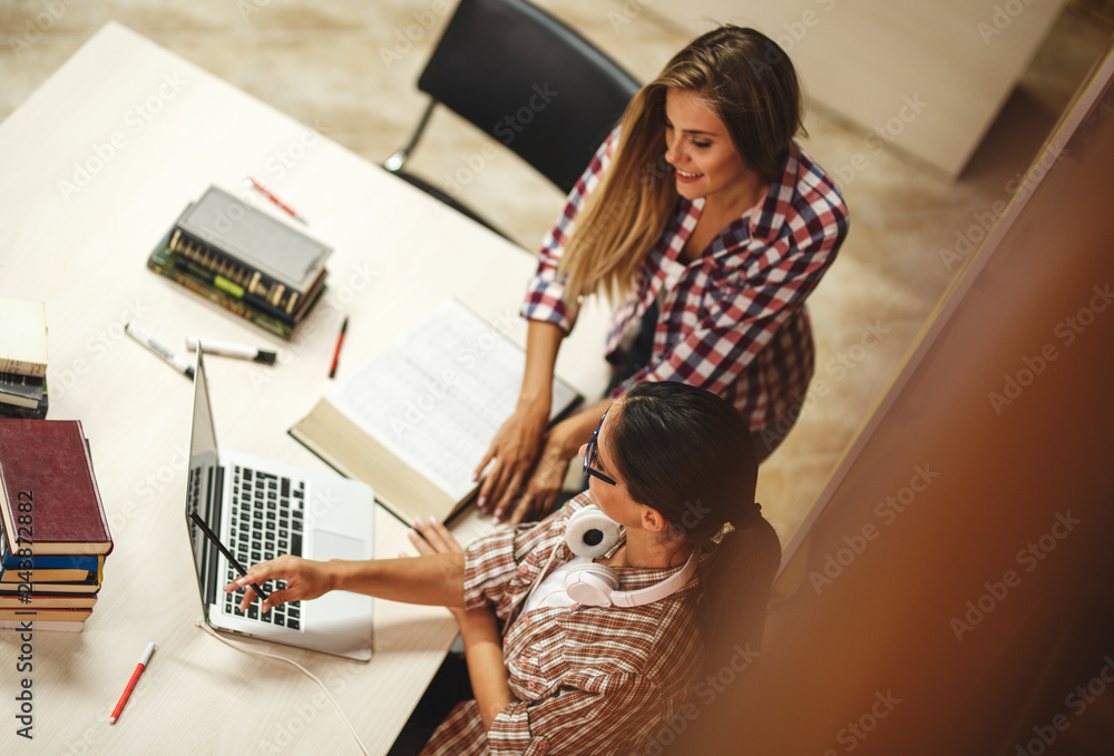 Two female students study in the school library.Learning and preparing ...