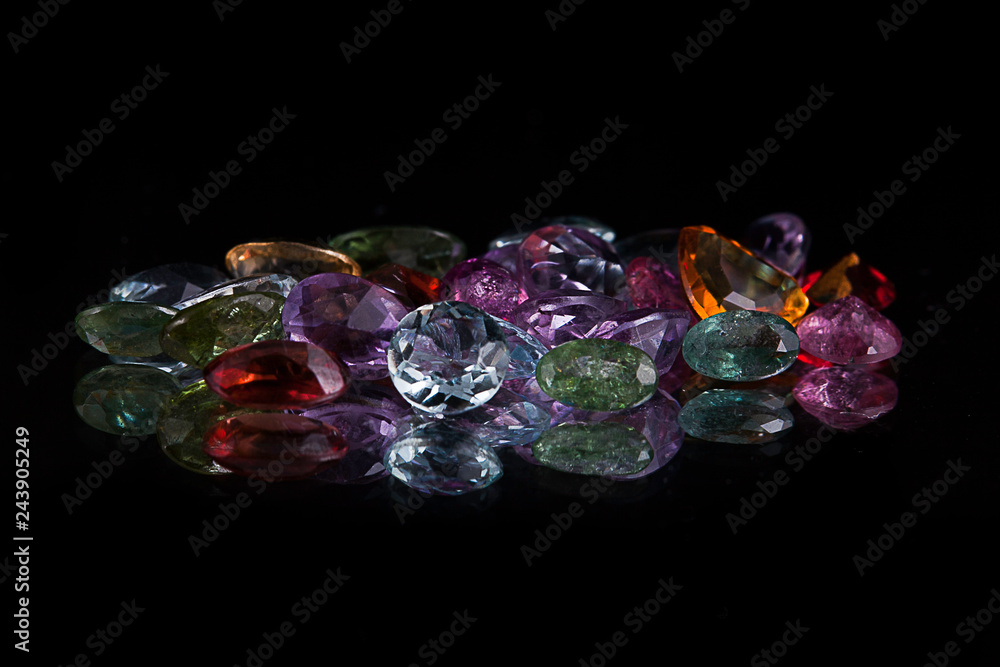 Group of transparent diamond shaped stones in all kinds of colours on a ...
