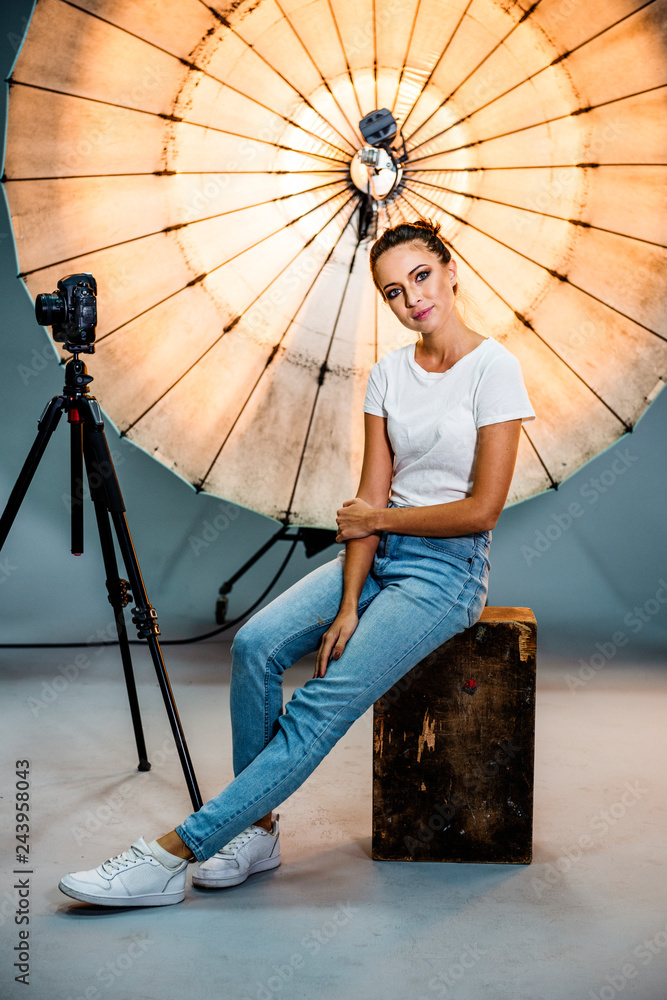 Model posing in front of a reflective umbrella in a studio Stock Photo ...