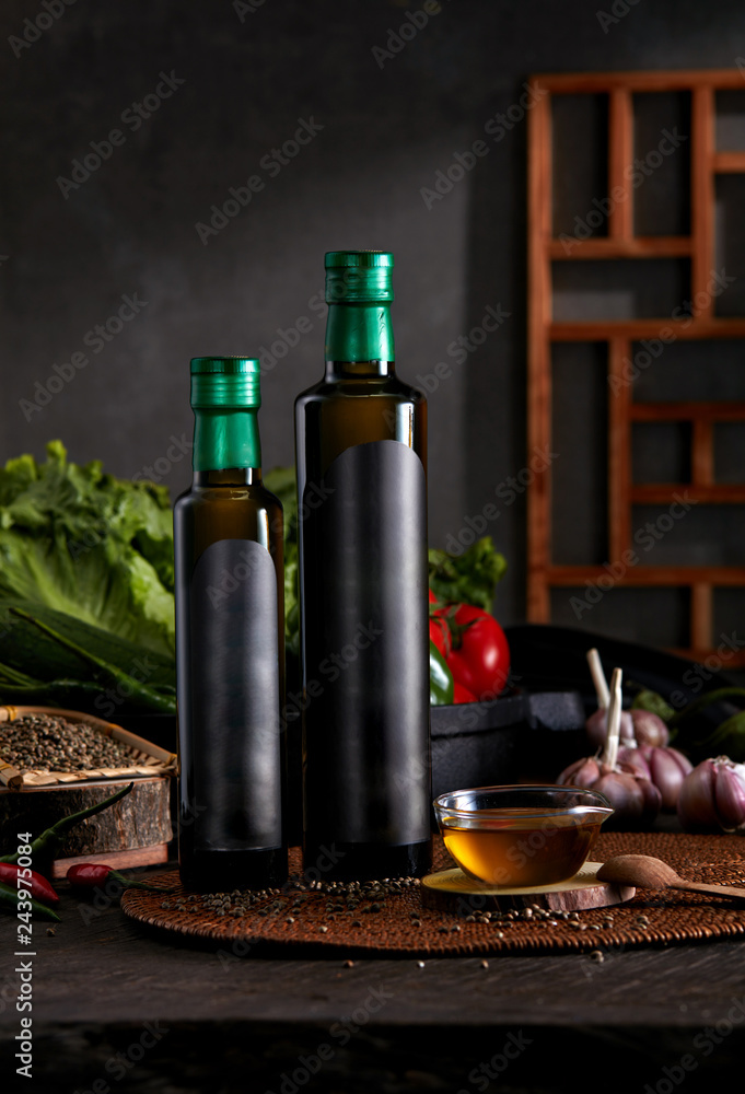 Black oil bottle in dark kitchen background Stock Photo | Adobe Stock