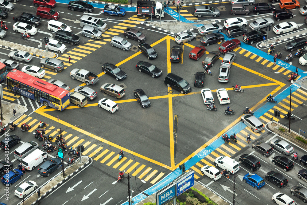 Aerial view looking down onto very busy intersection with heavy traffic ...
