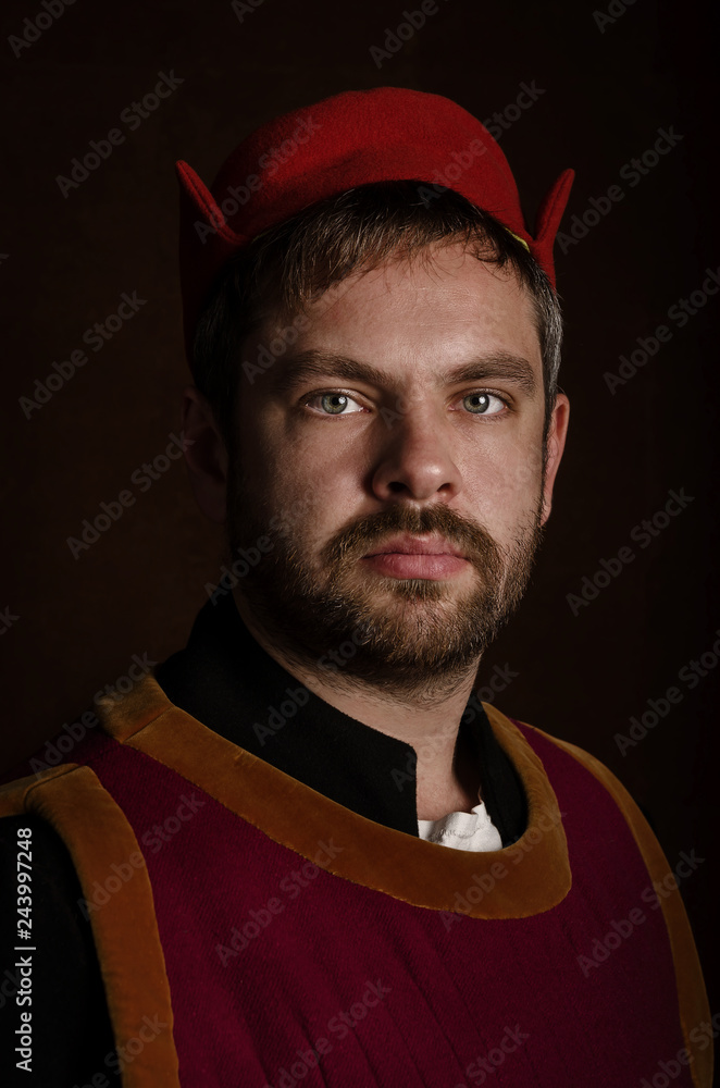 man (actor) in a 15th century costume (medieval) on an aged stylized ...