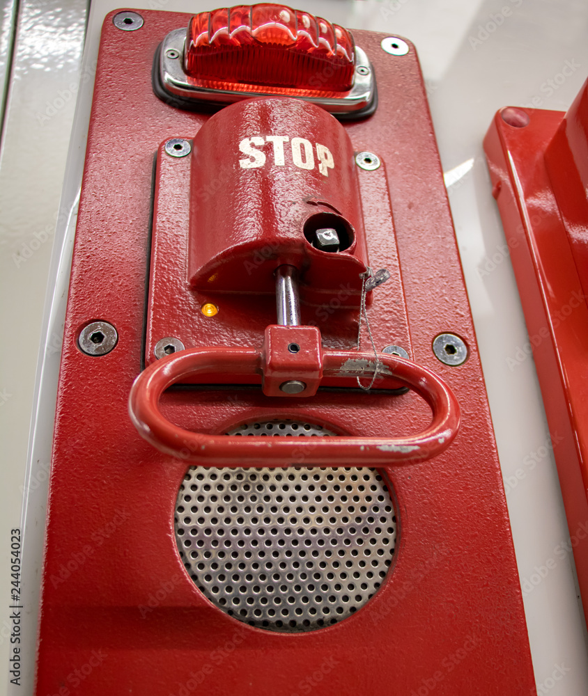 Red pull handle on wall. A emergency brake, close up. Fire alarm on ...