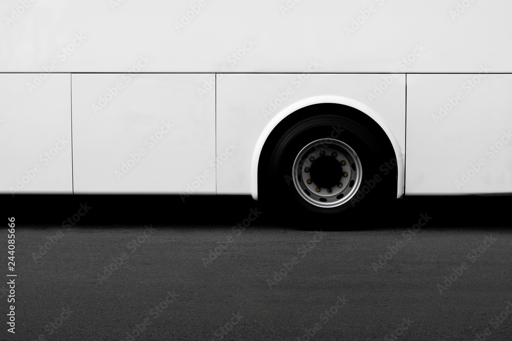Side view of a white bus wheel on an asphalt road. - copy space for ...