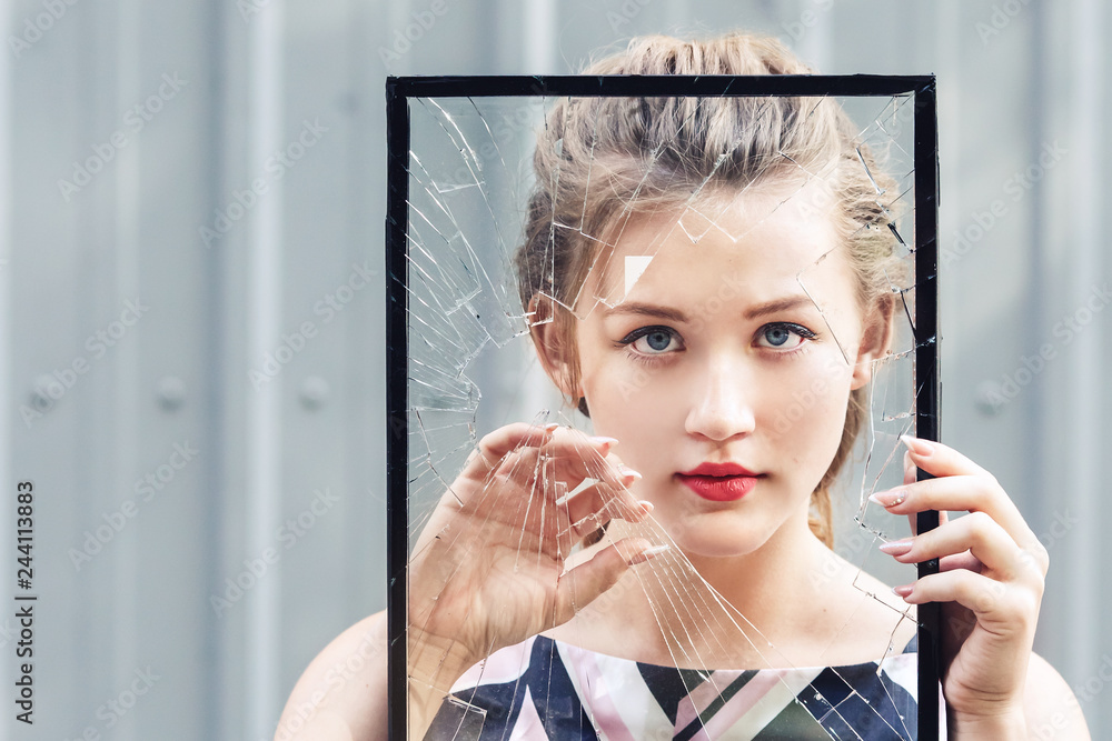 Beautiful teen girl holding broken glass in her hands. concept feminism ...