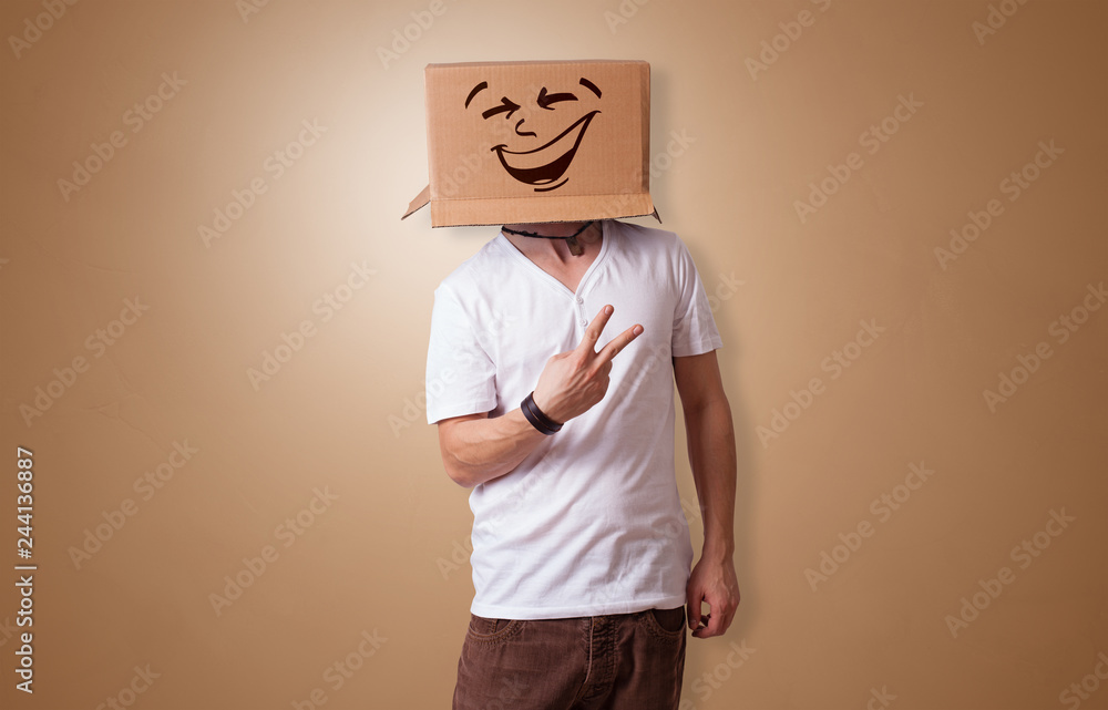 Young boy standing and gesturing with a cardboard box on his head Stock ...