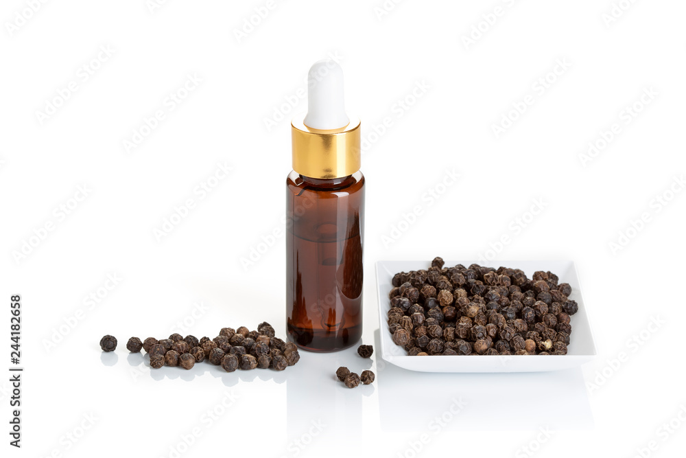 Black pepper essential oil isolated on white background. Black pepper ...