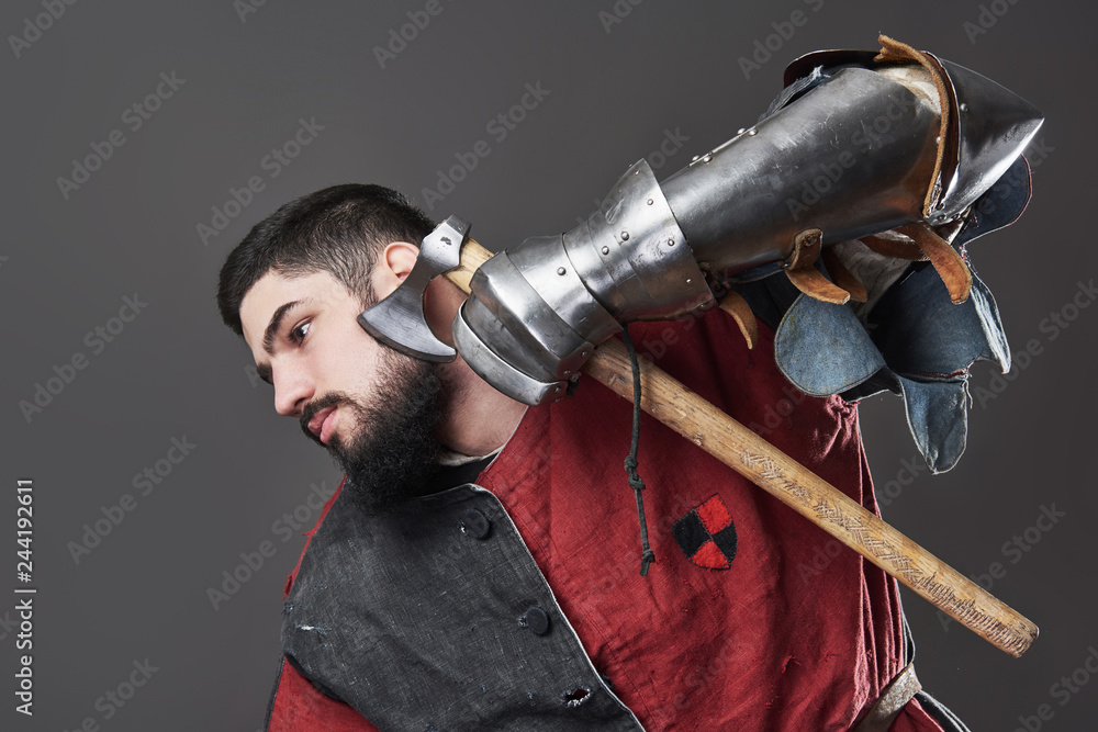 Medieval knight on grey background. Portrait of brutal dirty face ...