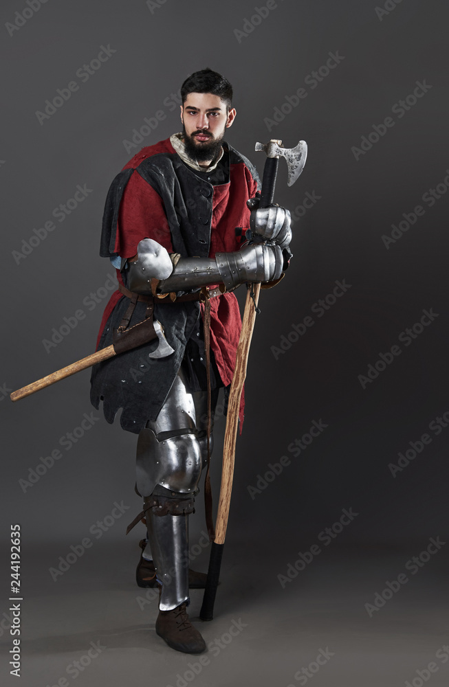 Medieval knight on grey background. Portrait of brutal dirty face ...