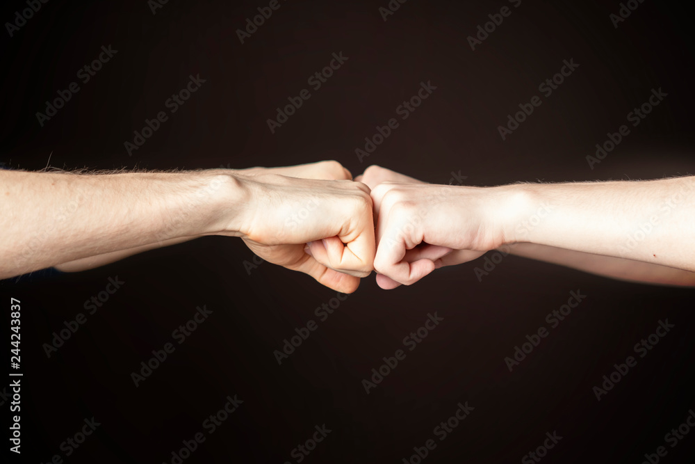Fist bump or Knuckle bump between two friends f Stock Photo | Adobe Stock