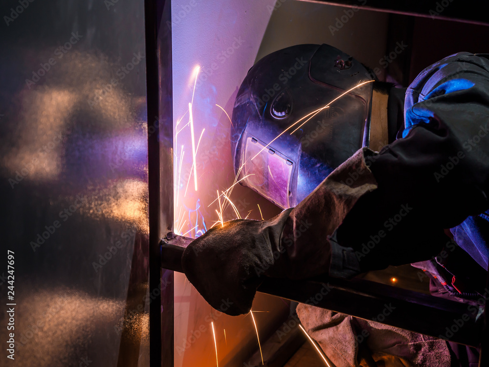 Welder Worker Performs Jump Welding. Worker Welder Performs Arc-Welding ...