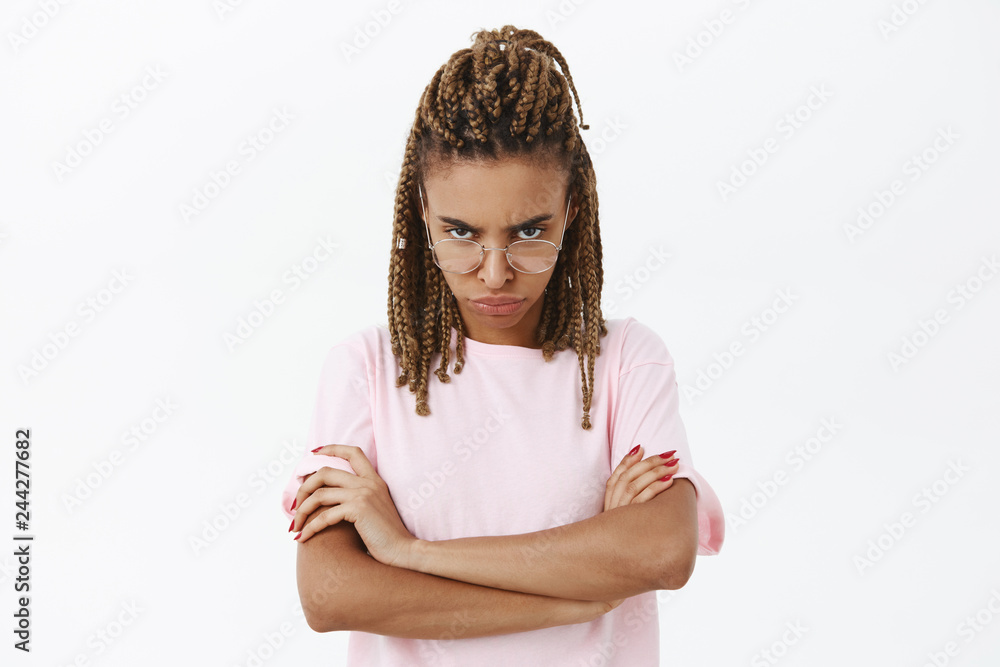 Serious-looking displeased and strict nerdy cute female with dark skin ...